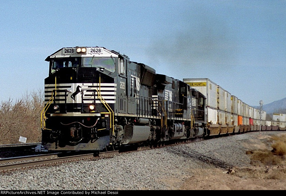NS SD-70M #2628 leads an all NS lashup with a westbound stacker at Jarales Rd.